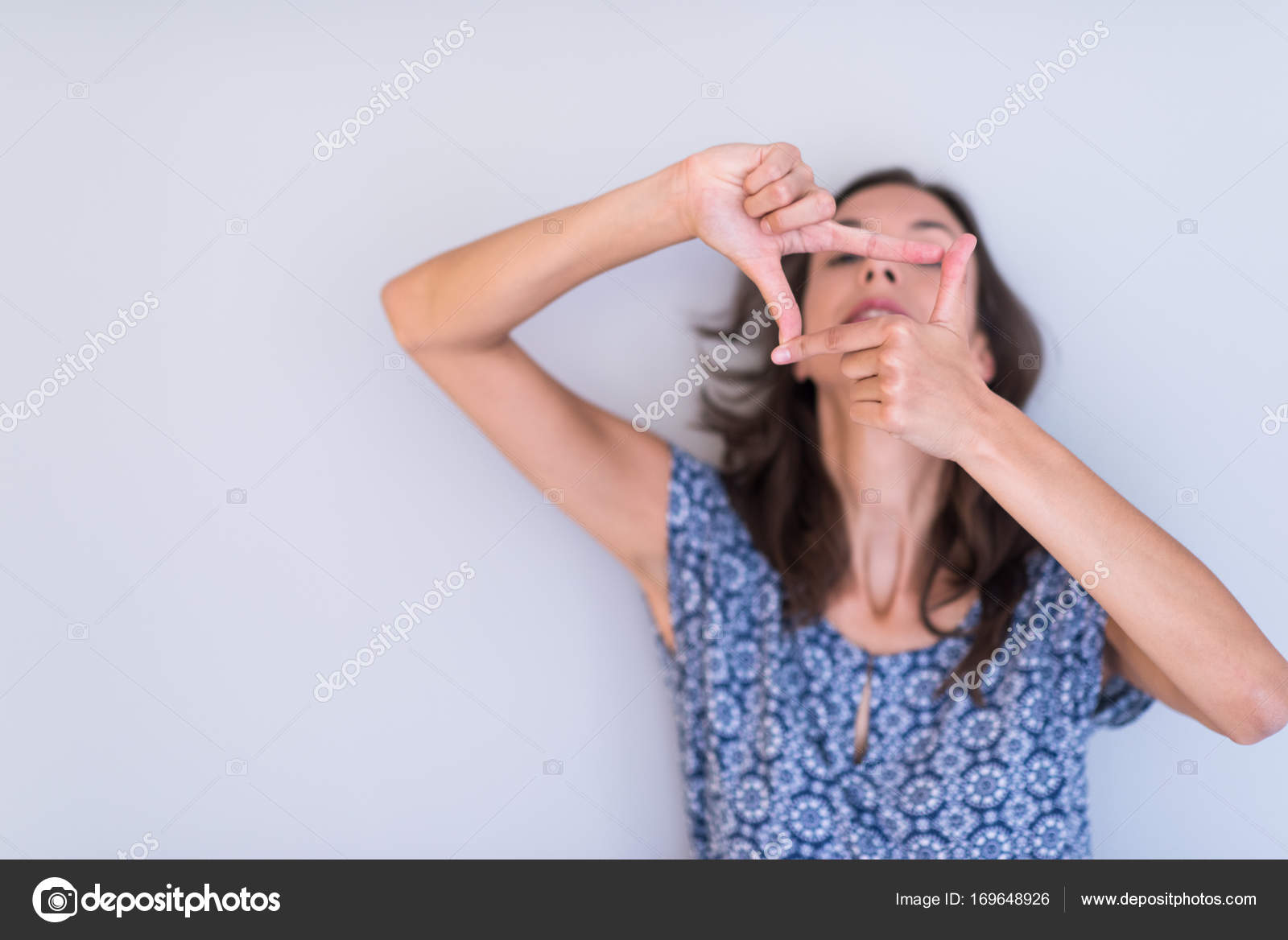 Woman showing framing hand gesture Stock Photo by ©.shock 169648926