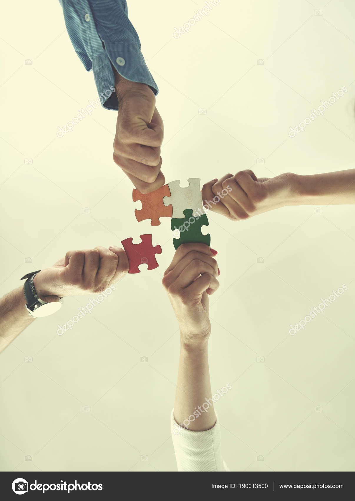 Group of business people assembling jigsaw puzzle Stock Photo by ...