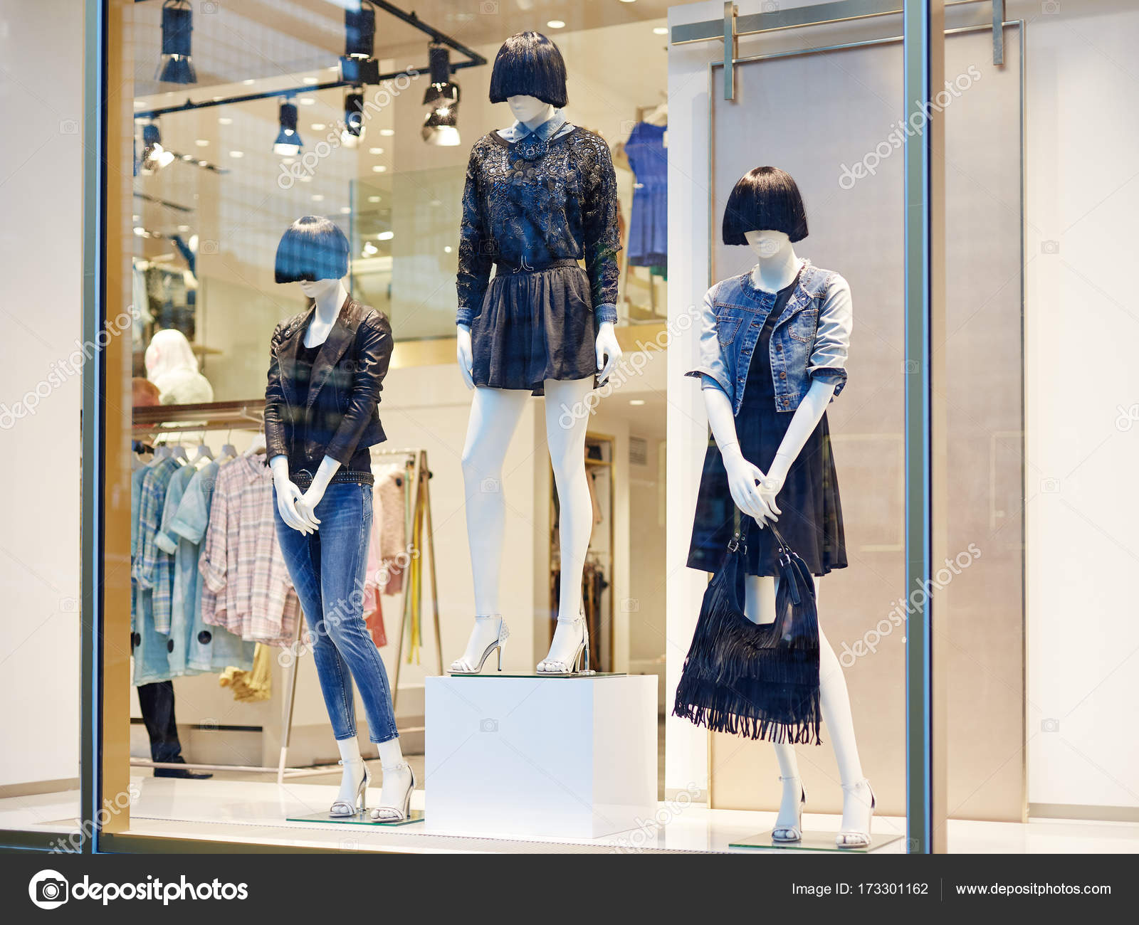 Mannequins standing in store window display of women s casual cl ...