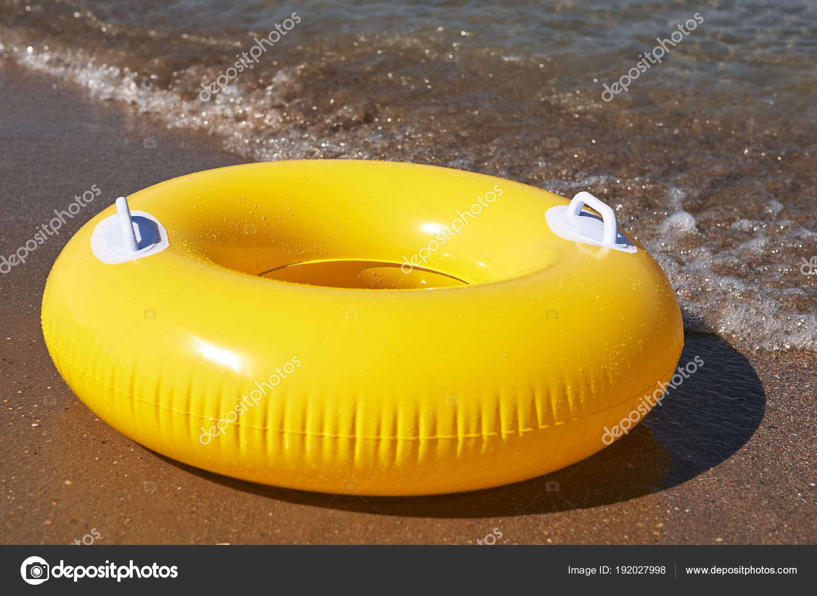 Yellow swim ring floating on a sea Stock Photo by ©Sergios 192027998