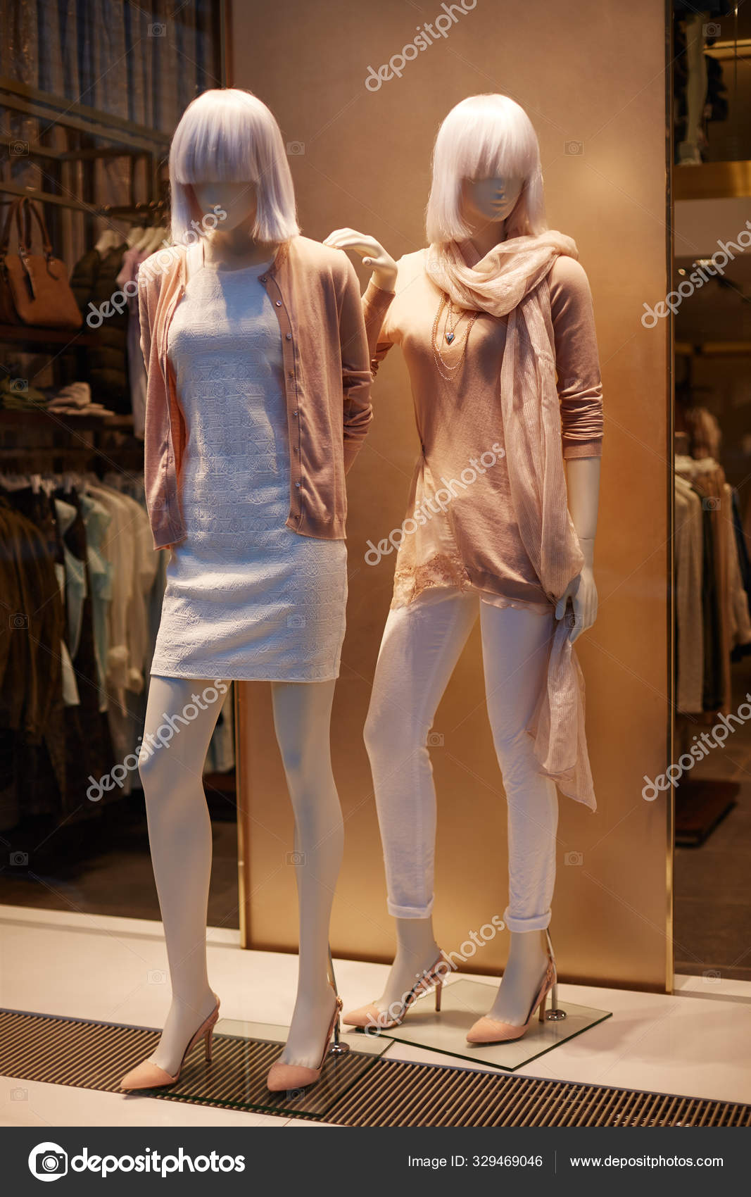 Mannequins standing in store window display of womens casual clo ...