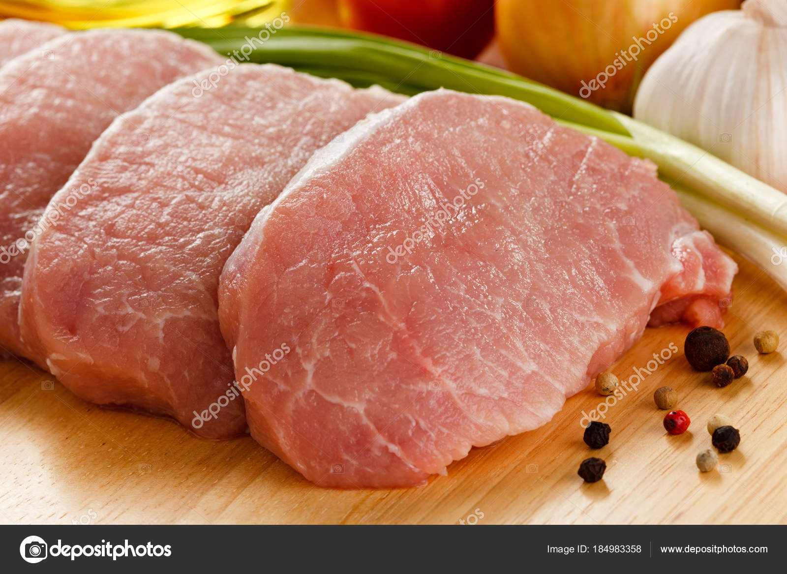 Raw Pork Chops Cutting Board Vegetables Stock Photo by ©gbh007 184983358