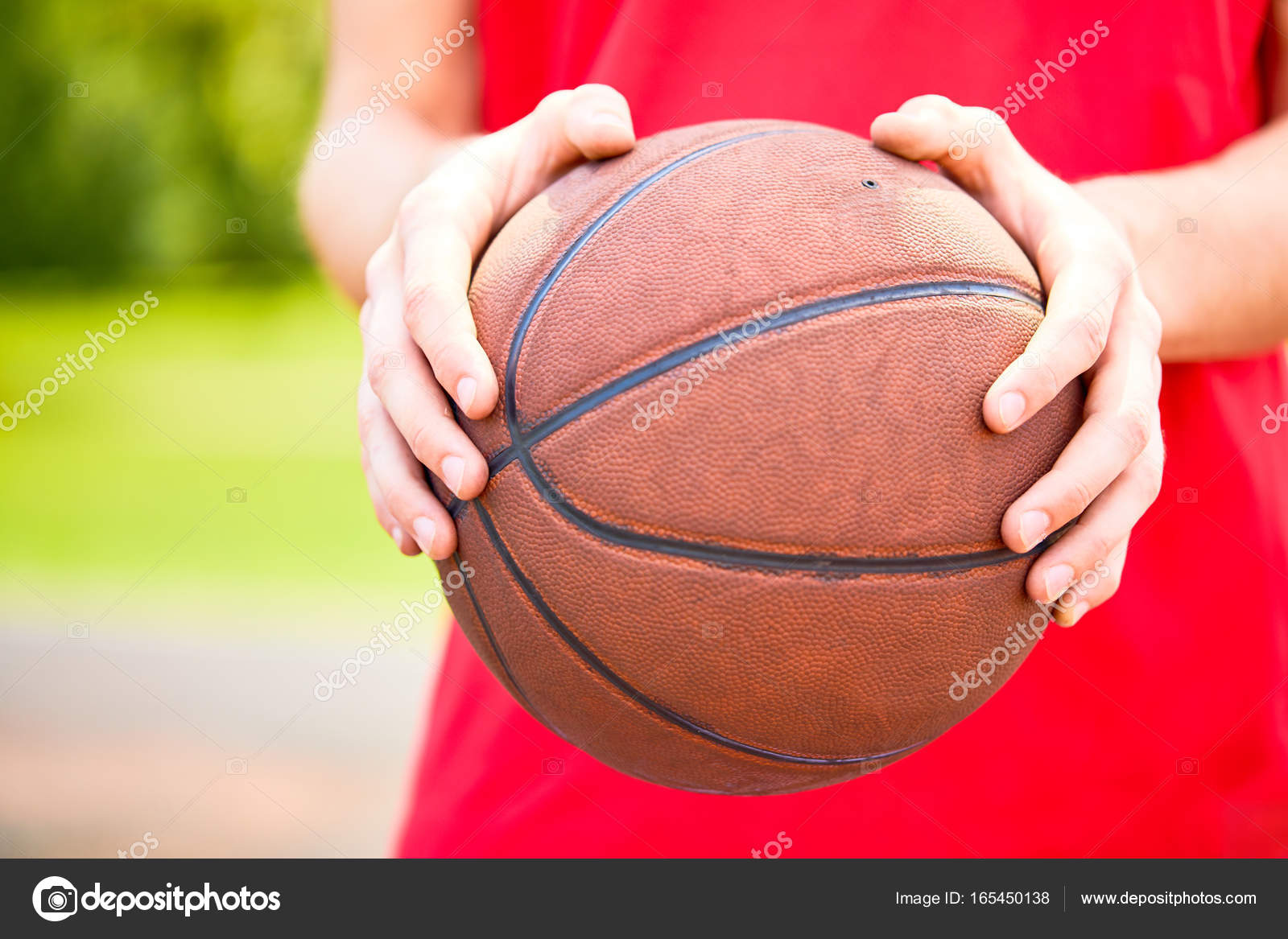 Hand Holding Basketball