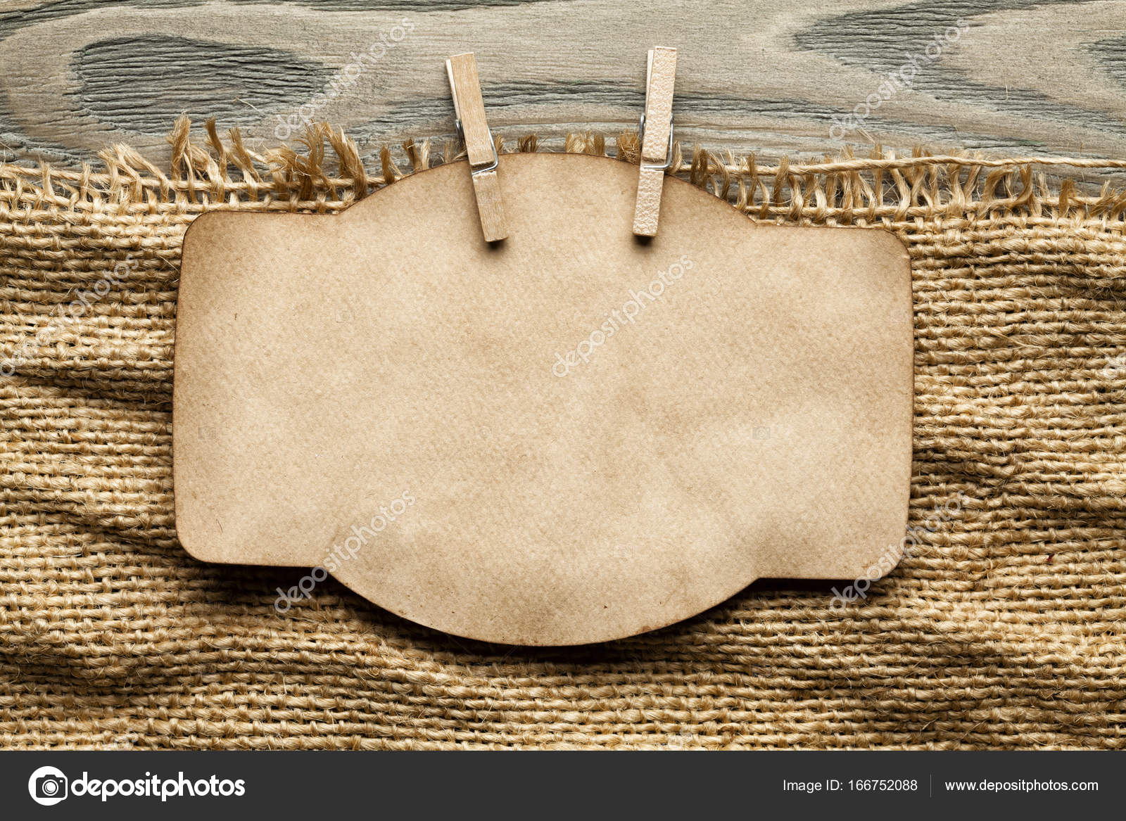 Blank paper label on canvas and wooden background Stock Photo by ...