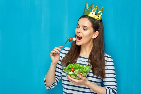 young woman with crown on head eating diet food green salad, healthy ...