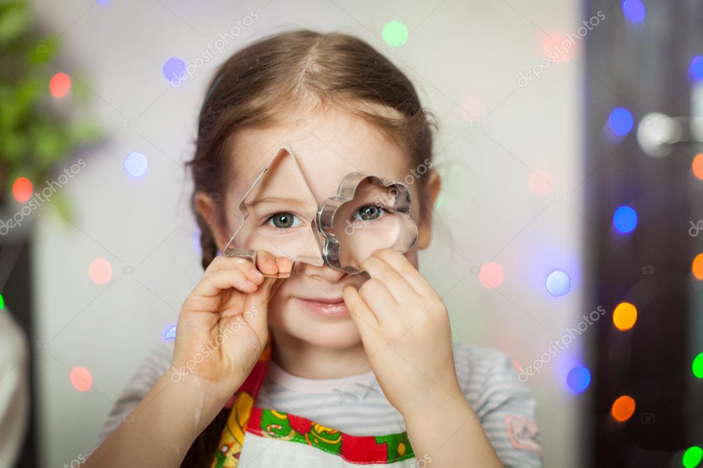 Little girl playing with cookie cutters Stock Photo by ©gorchichko ...