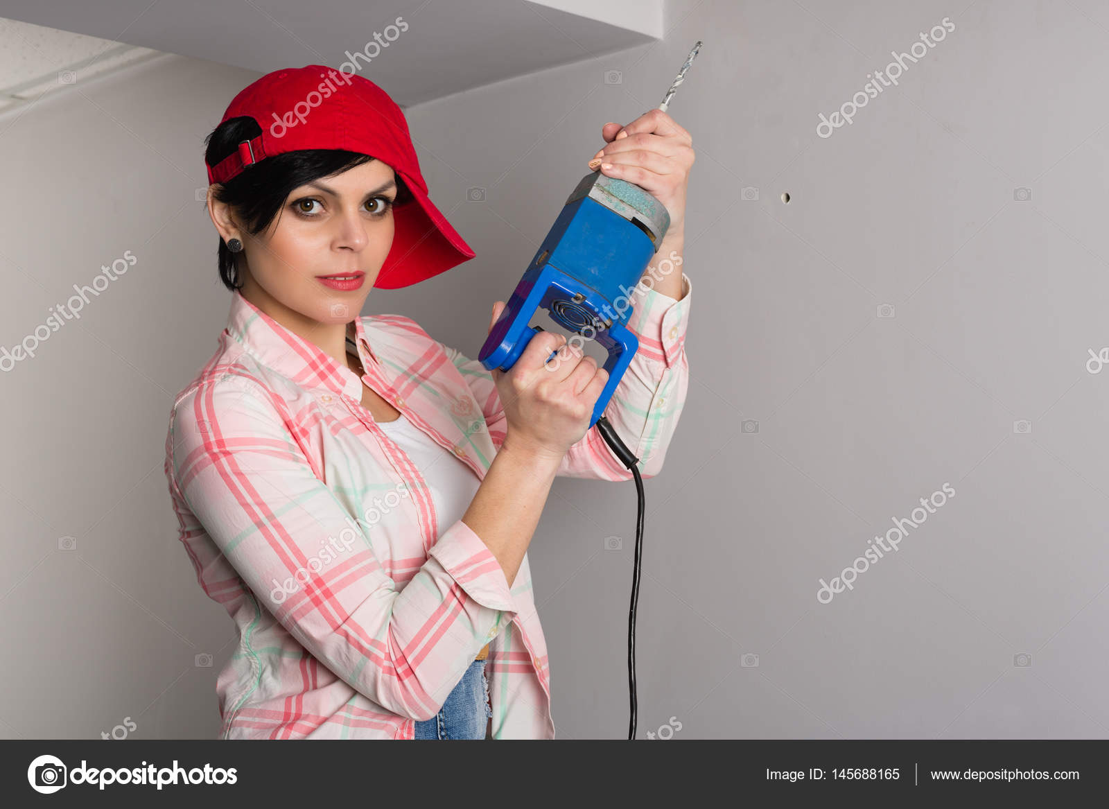 Young woman with an old builder with drill Stock Photo by ©Stas_K 145688165