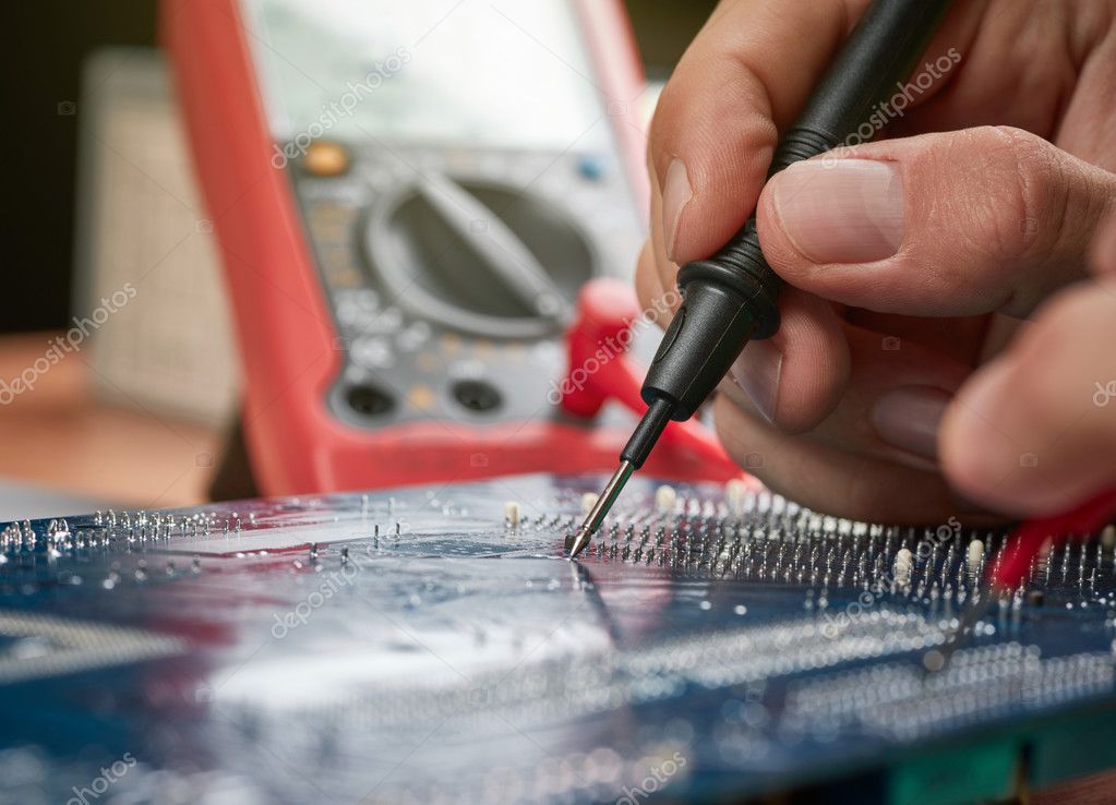 Technician checking motherboard with tester. Stock Photo by ©silverjohn ...
