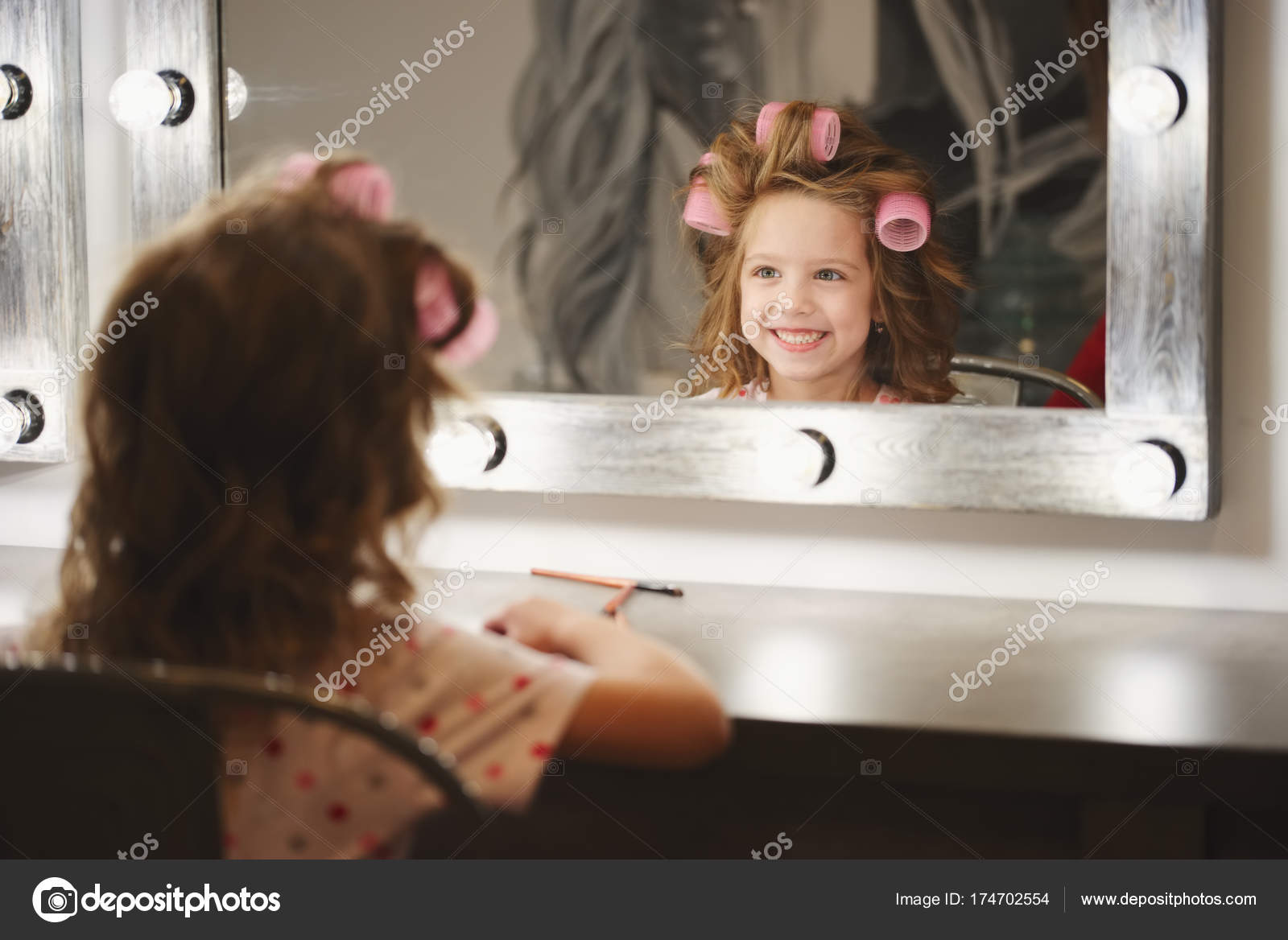 Cute little girl making make-up Stock Photo by ©ababaka 174702554