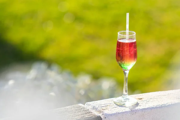 Glass, cocktail with straws. Cold drinks at the resort on blurred ...