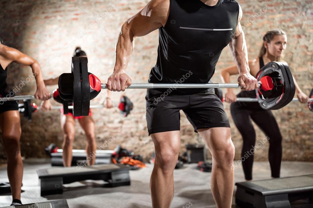 Muscular sporty people doing workout Stock Photo by ©luckybusiness ...
