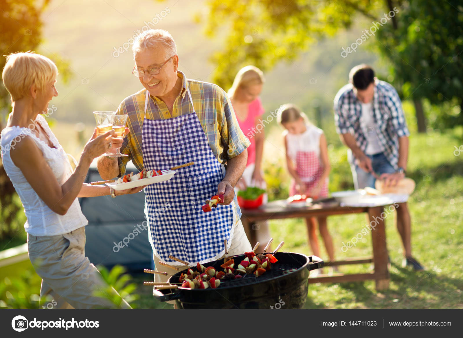 Happy family having a barbecue party — Stock Photo © luckybusiness ...