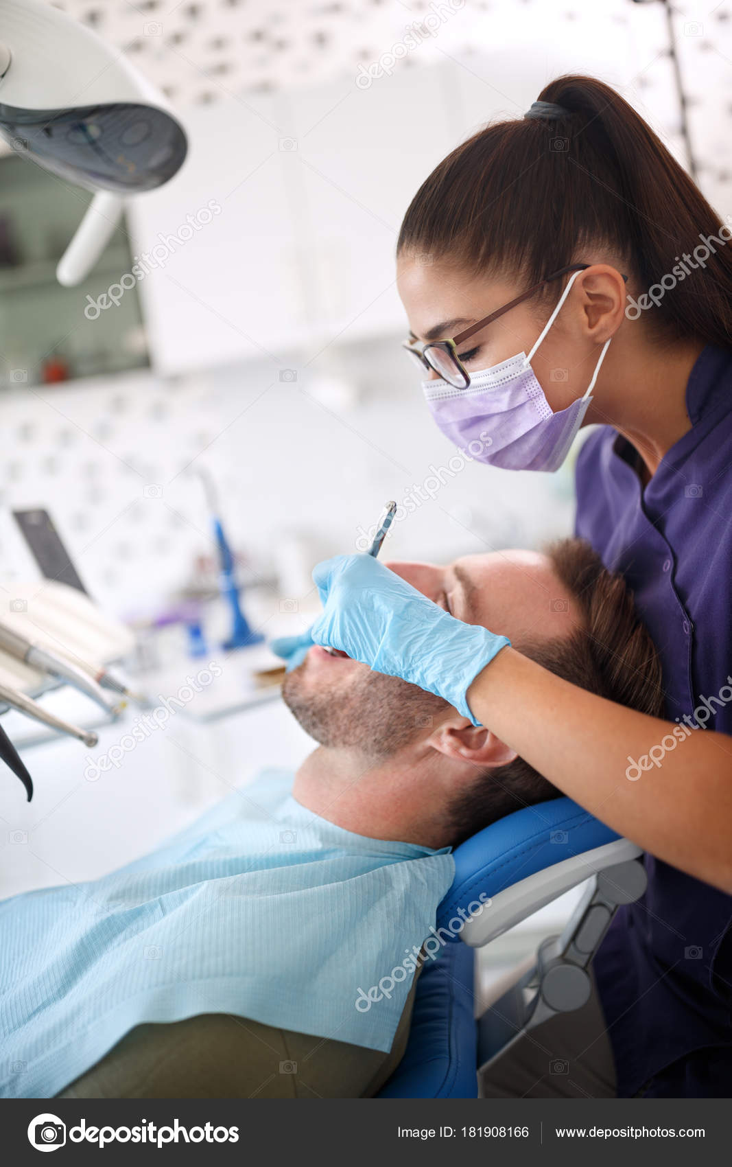 Dentist at work with patients in dental clinic Stock Photo by ...