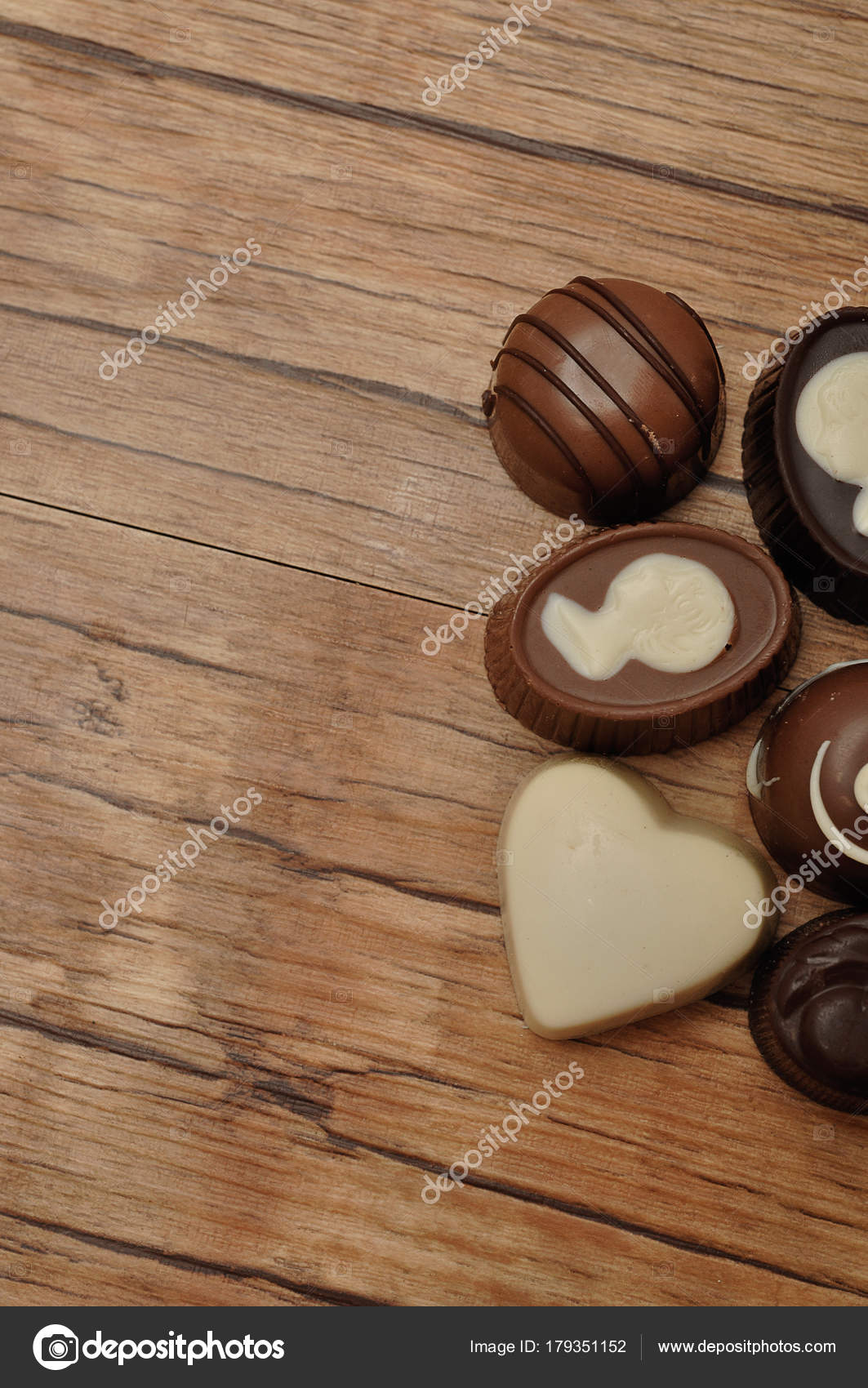 A variety of small chocolates on a wooden background — Stock Photo ...