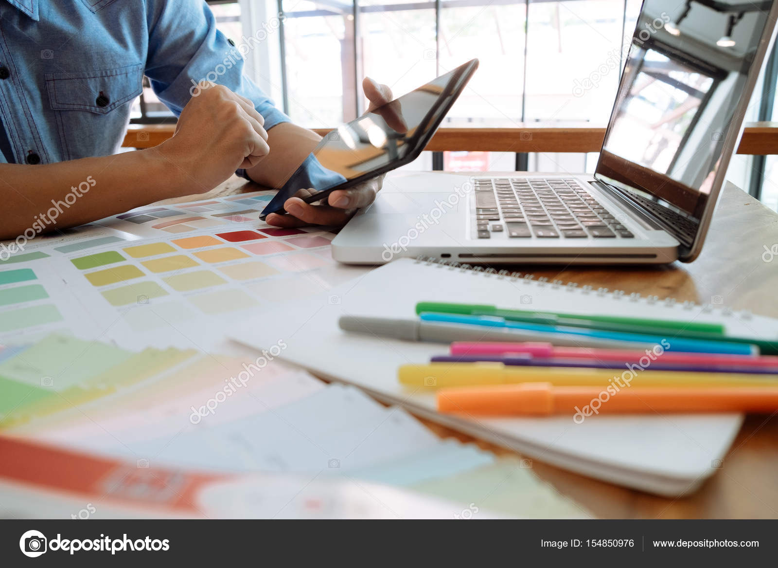 Creative photographer select pictures and using computer to work ...