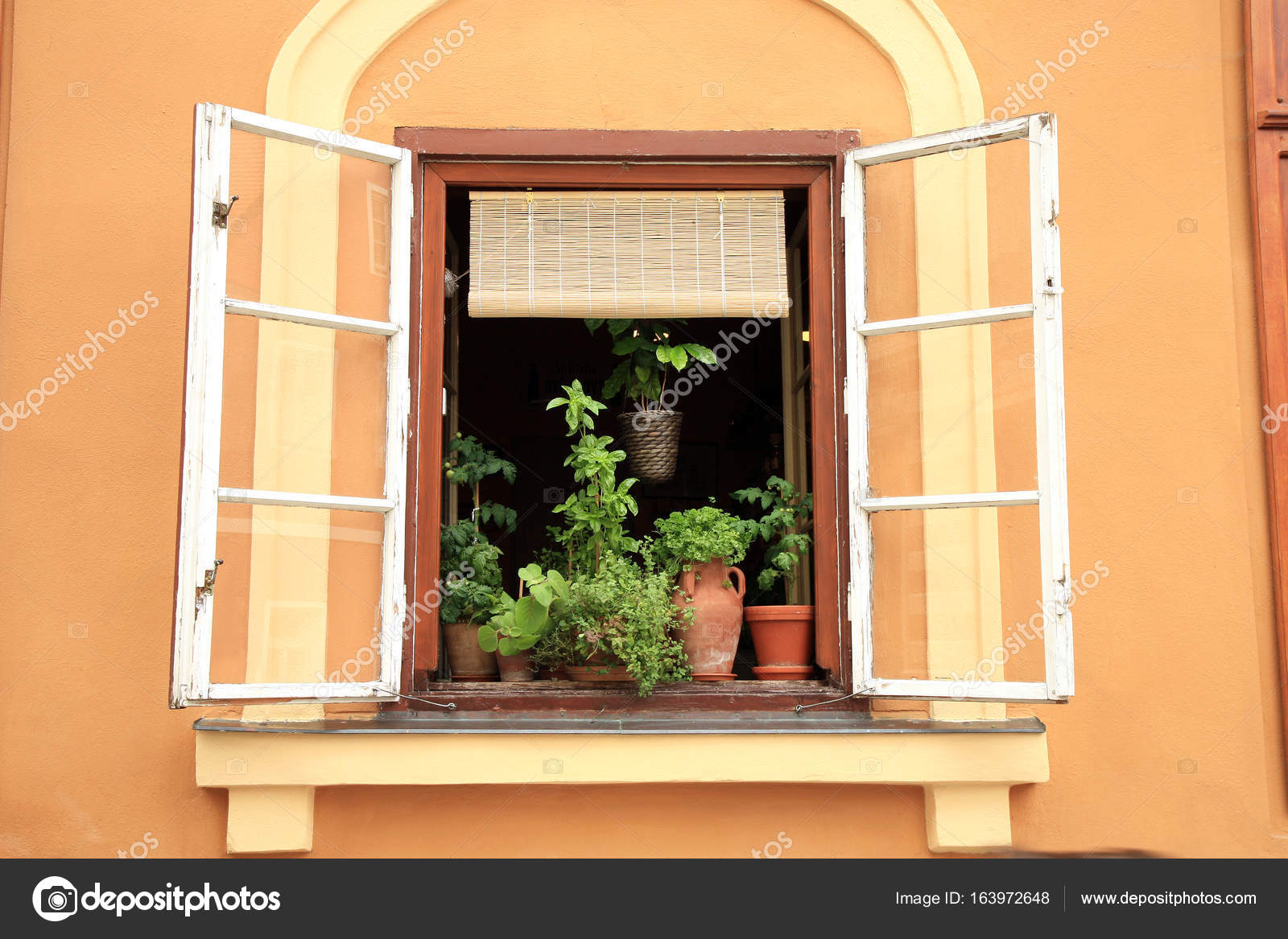 Flowers in the open window with bench Stock Photo by ©fotokate 163972648