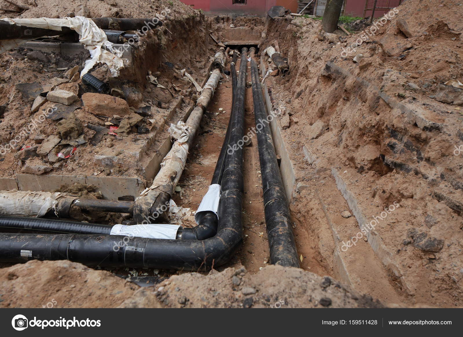 Sewer pipe in the trench — Stock Photo © Omstudio #159511428
