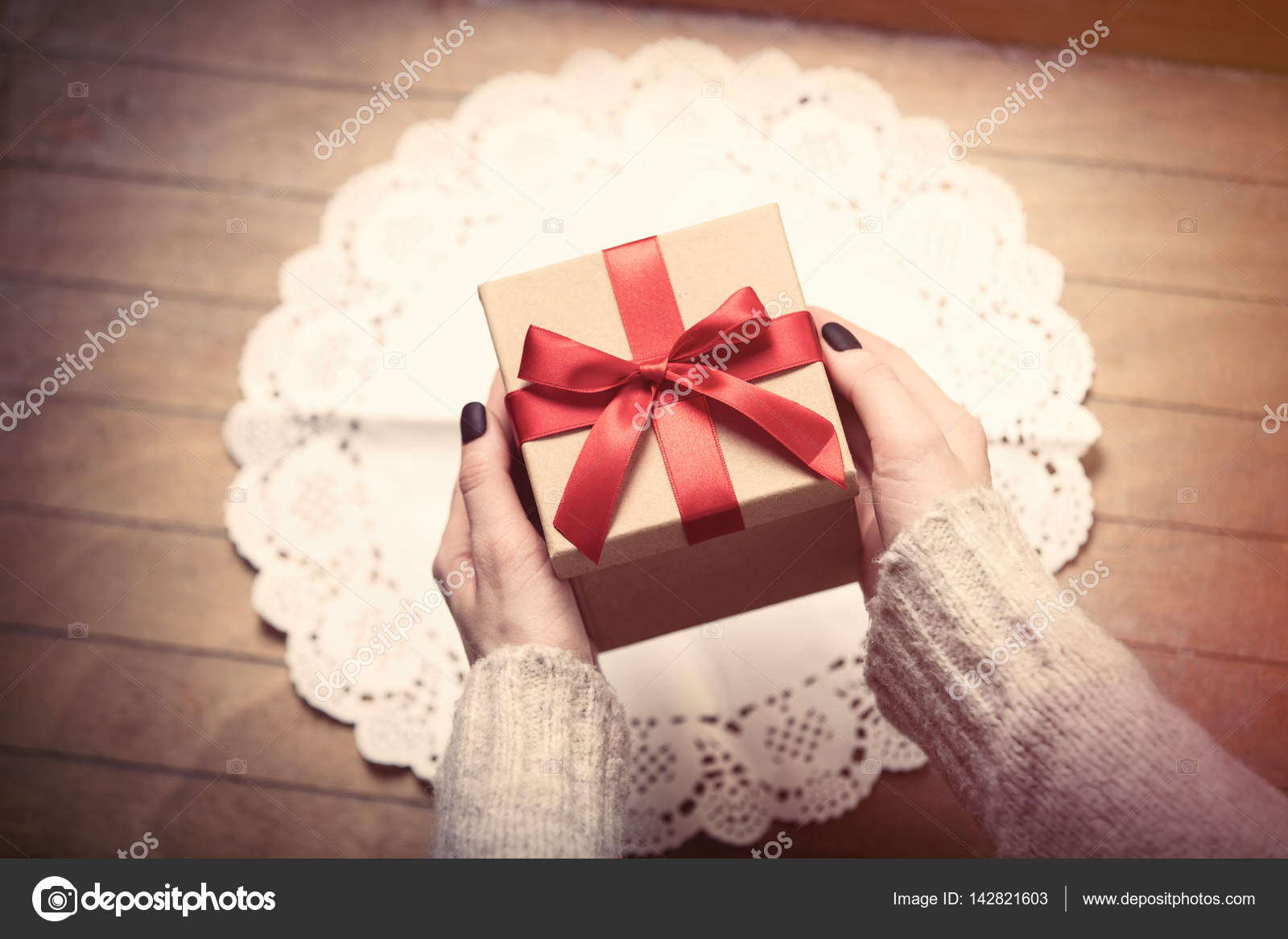 Hands holding gift Stock Photo by ©massonforstock 142821603