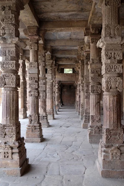 Columns with stone carving in courtyard of Quwwat-Ul-Islam mosque ...