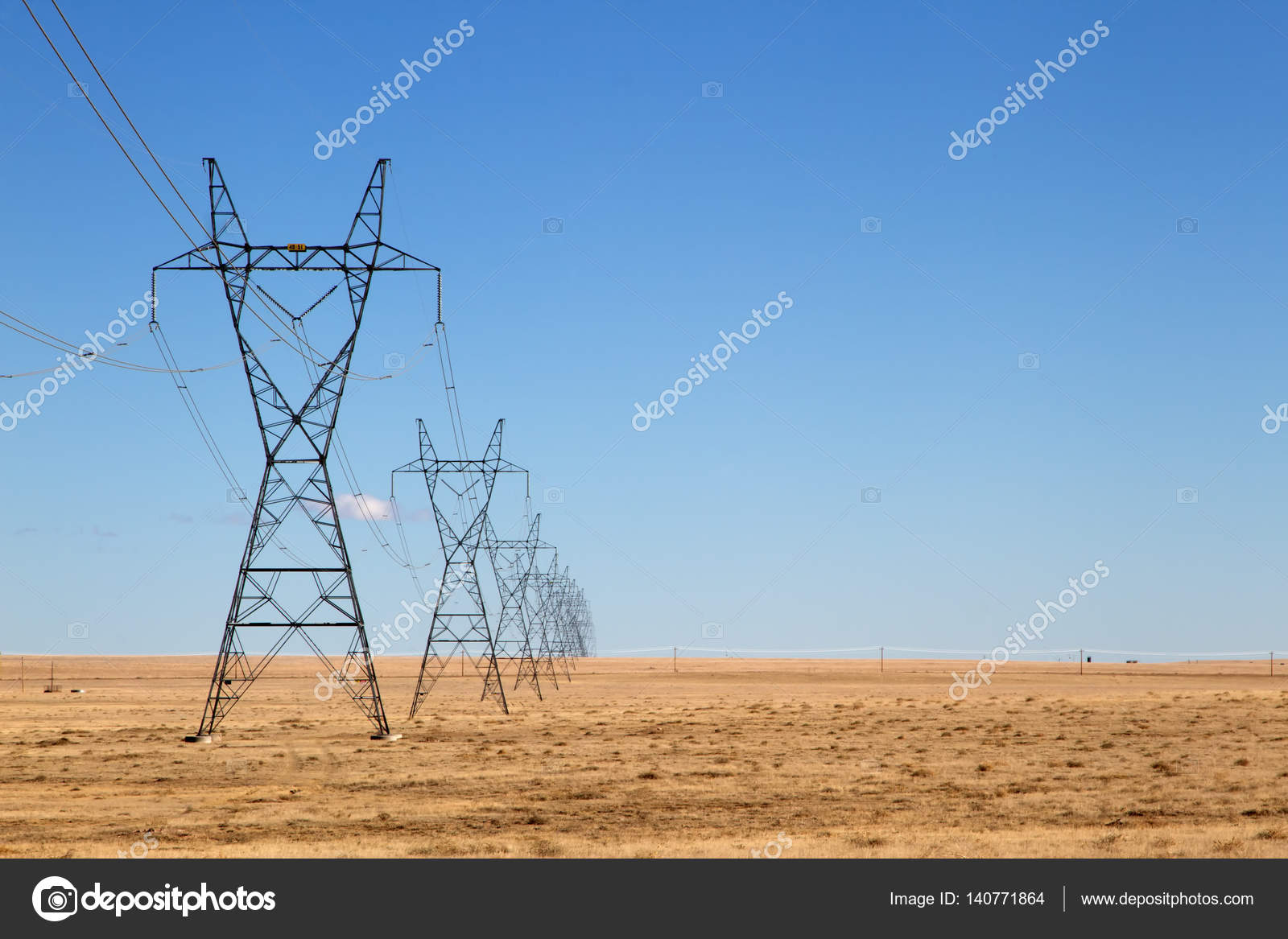 Row High Voltage Power Lines under a Blue Sky Stock Photo by ...