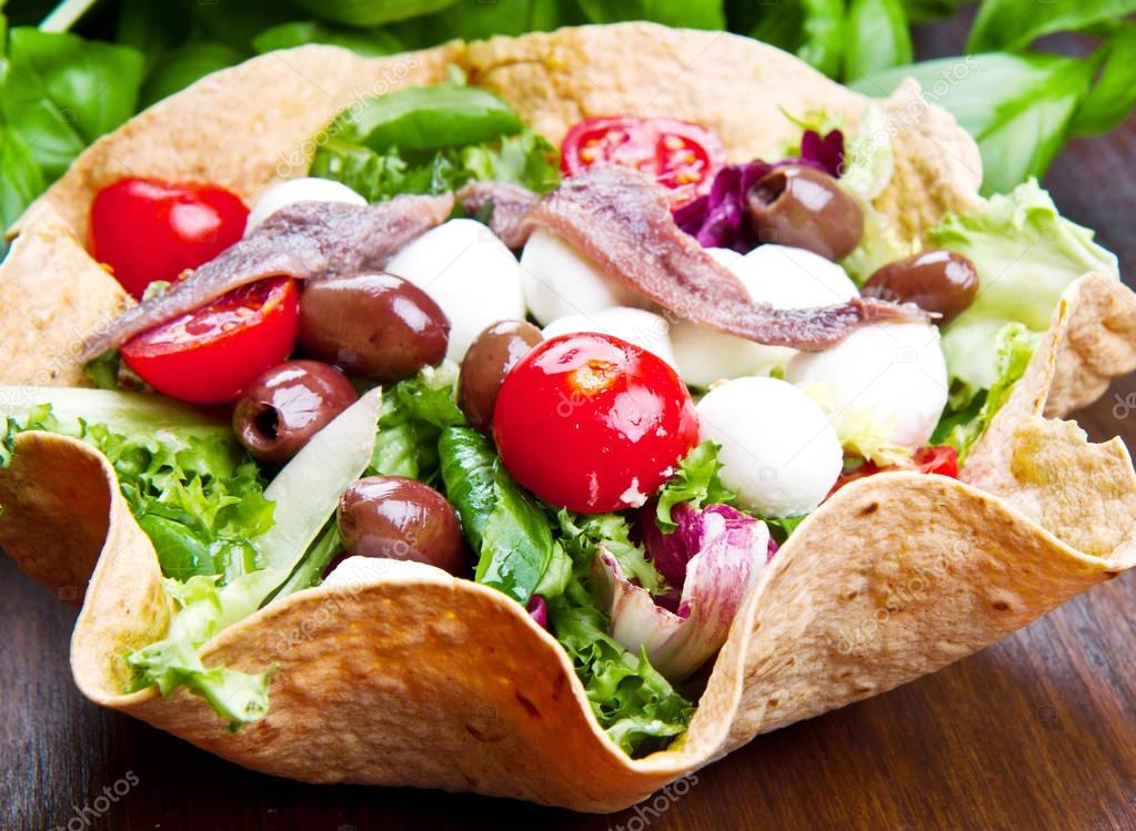 Mixed salad with mozzarella and anchovy Stock Photo by ©lsantilli 129536026