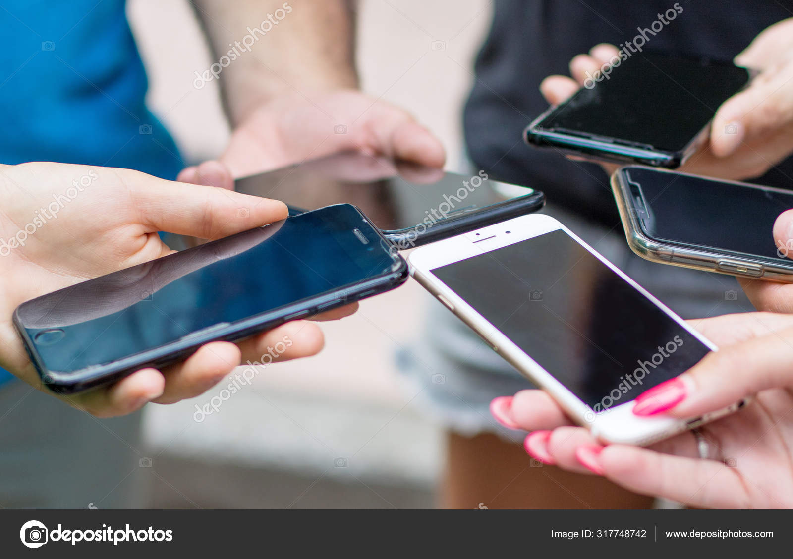 A Group Of People Using Iphone