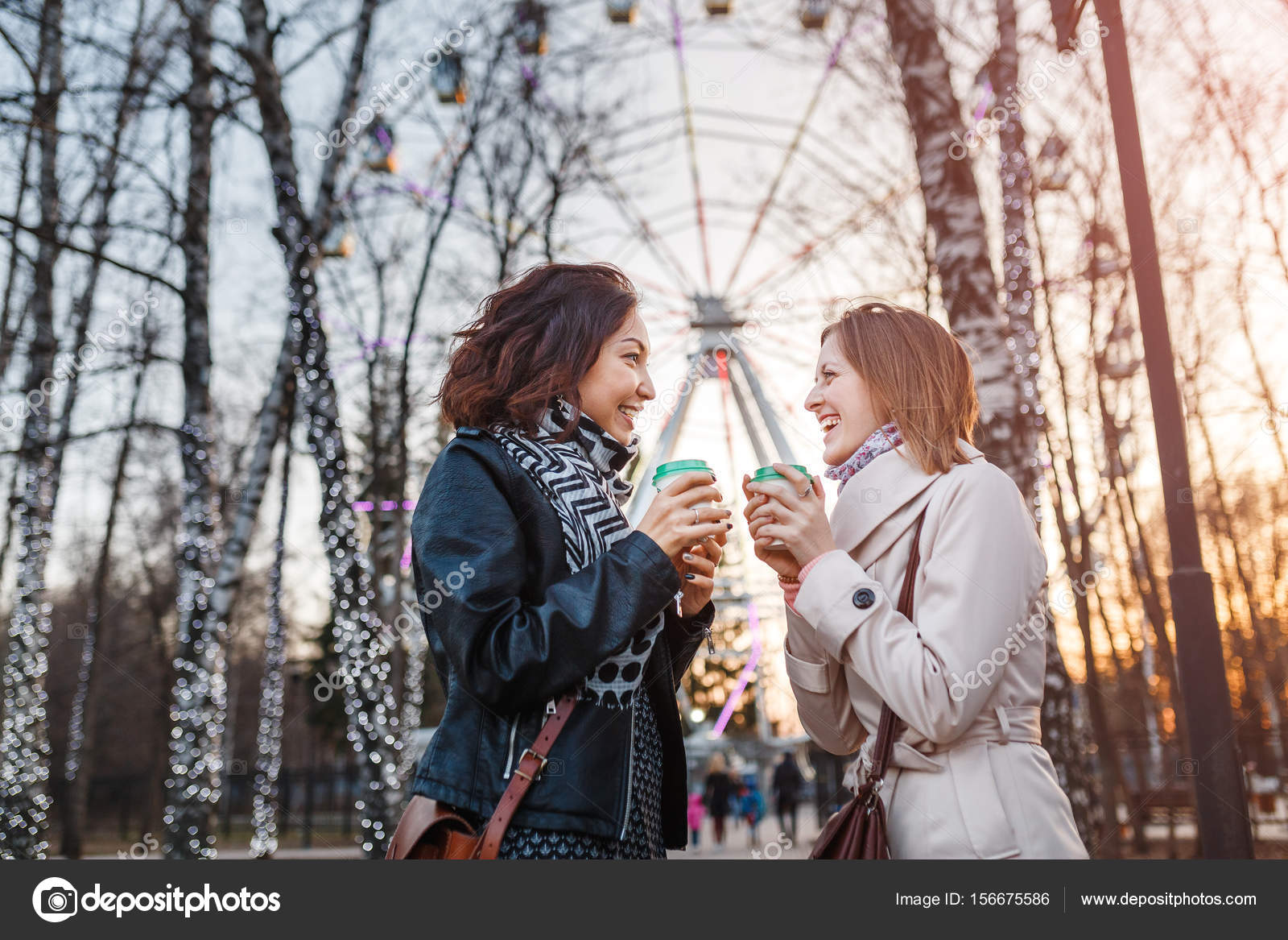 Lifestyle portrait of two best friends girls with cup of takeaway cups ...