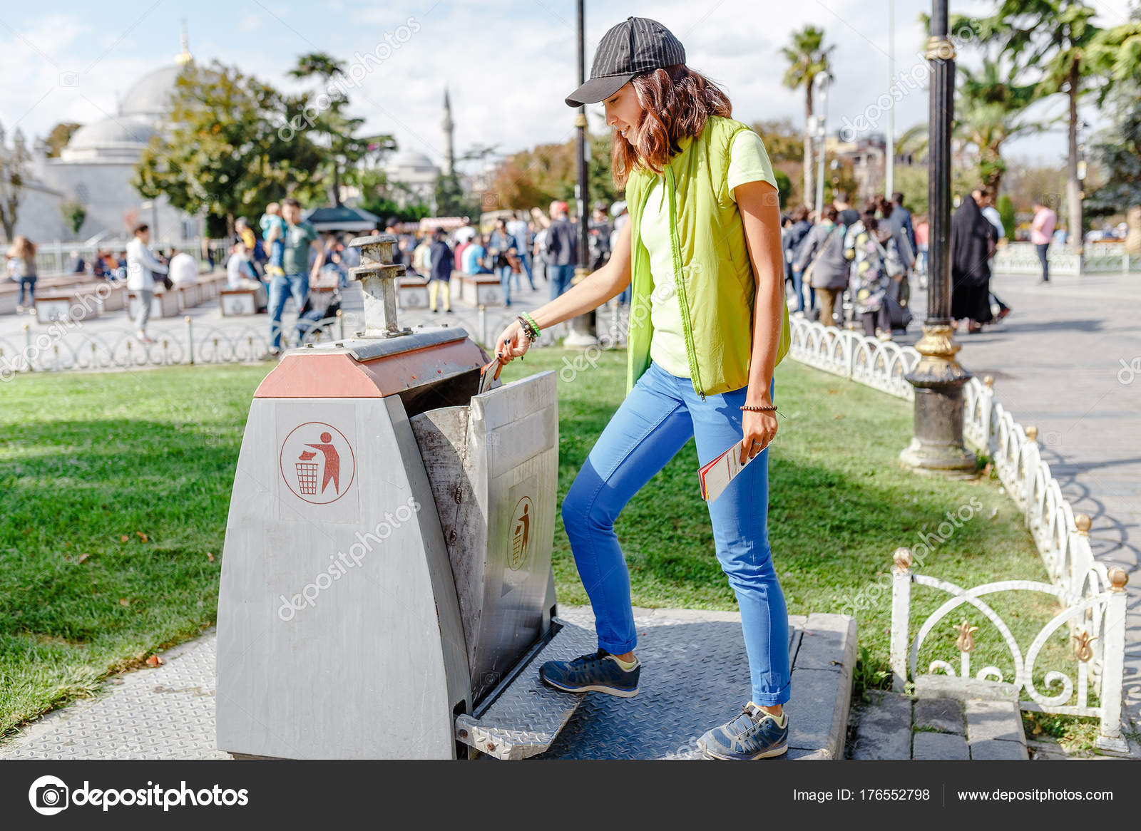 Woman throwing garbage in trash bin outside in Istanbul city park Stock ...