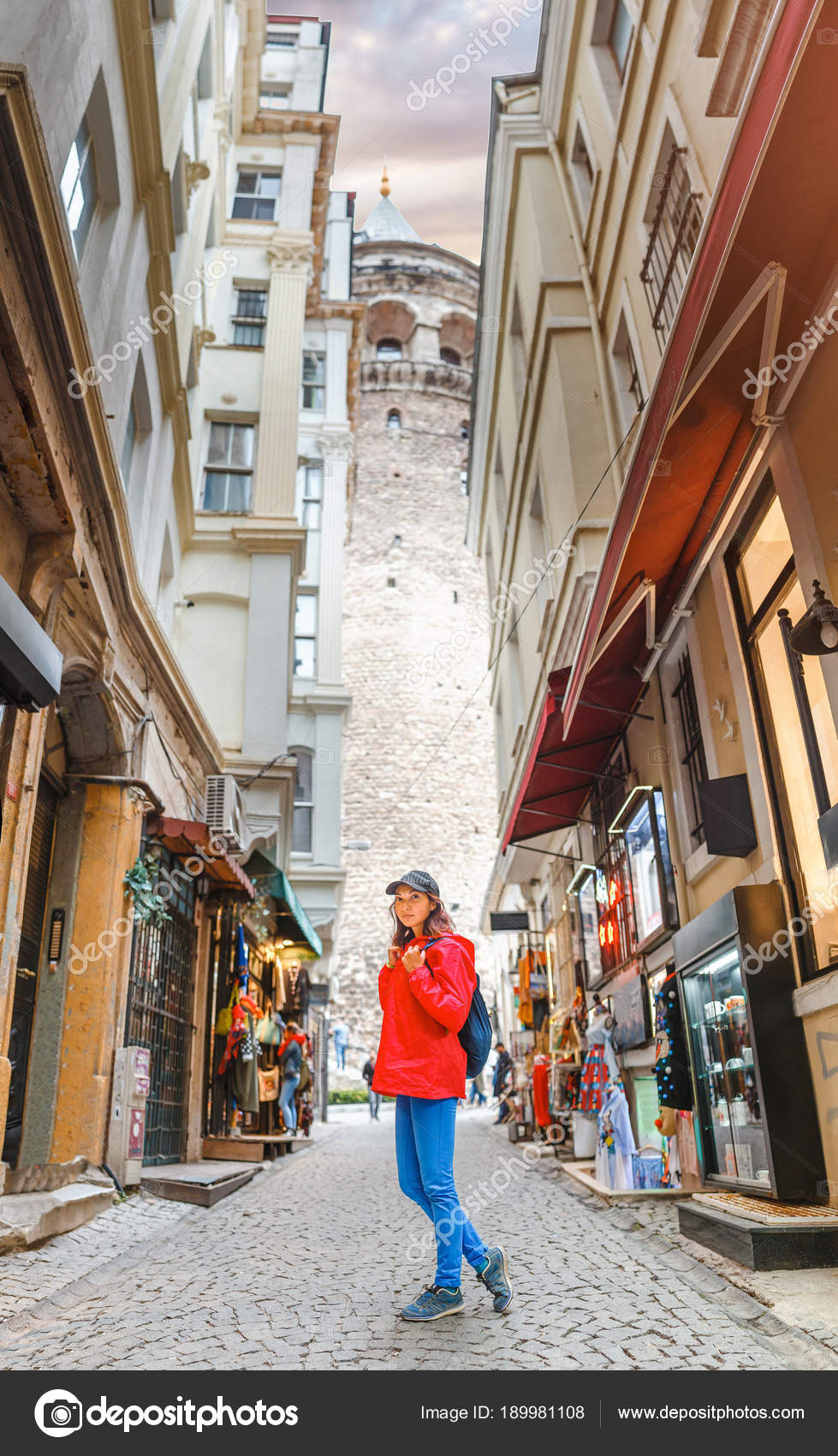 Young happy tourist woman walking near Galata Tower and the street in ...