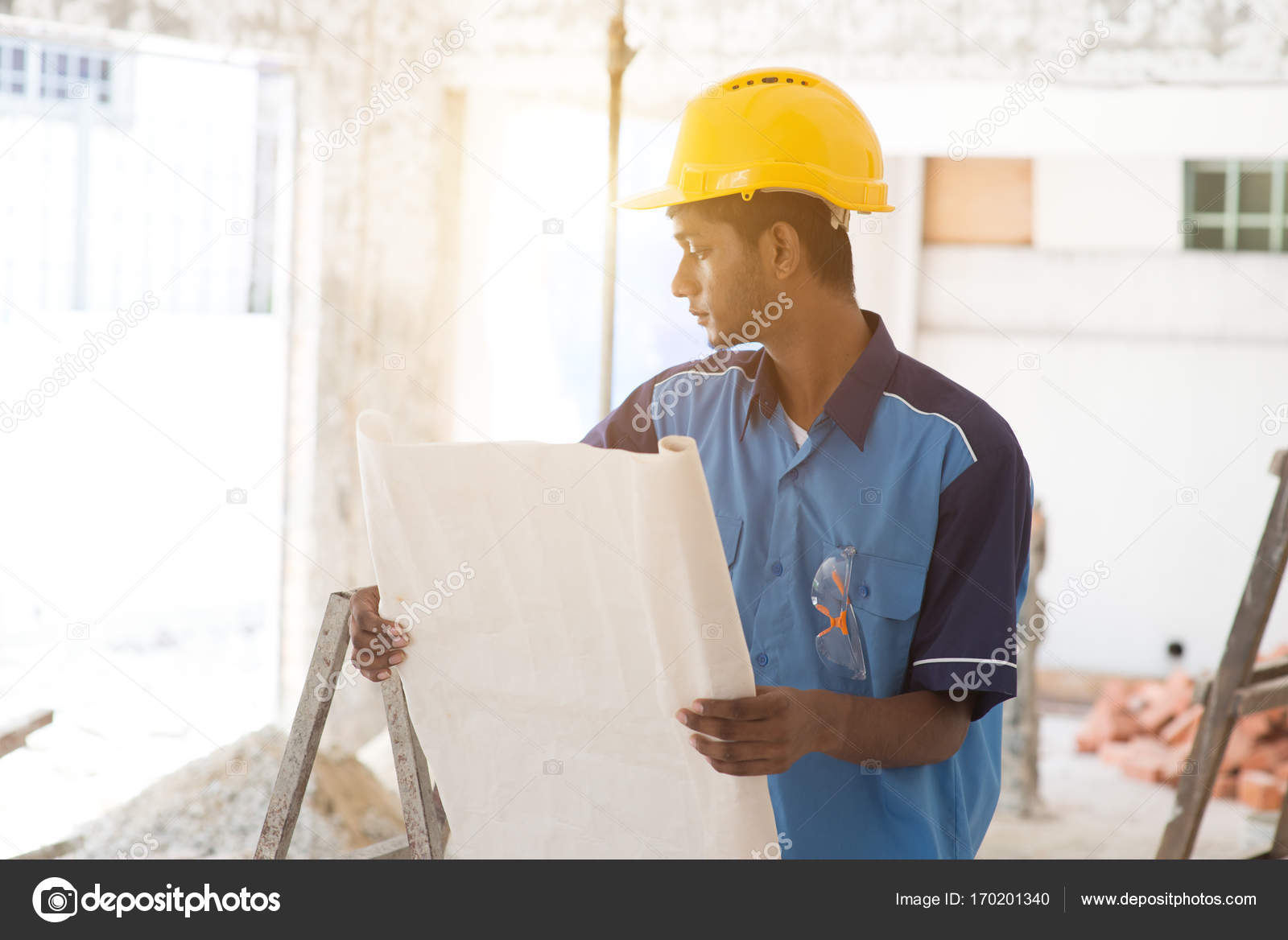 Construction worker looking at plans Stock Photo by ©yuliang11 170201340