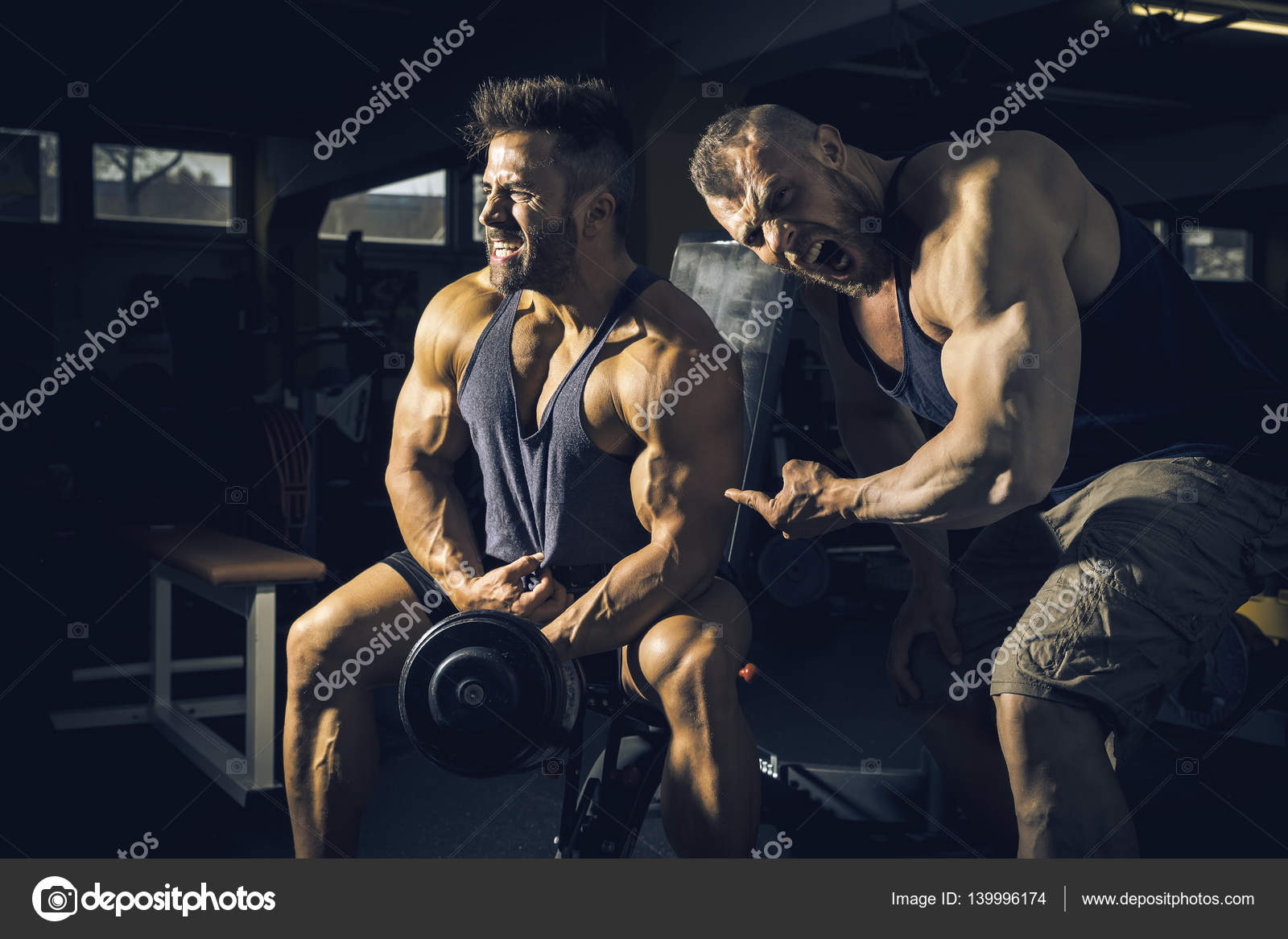 Dos hombres entrenando en el gimnasio: fotografía de stock © magann ...