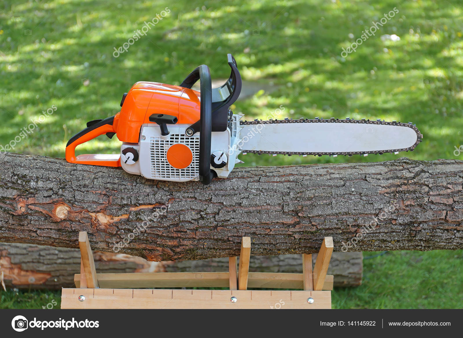 Chainsaw at Wood Log Stock Photo by ©Baloncici 141145922