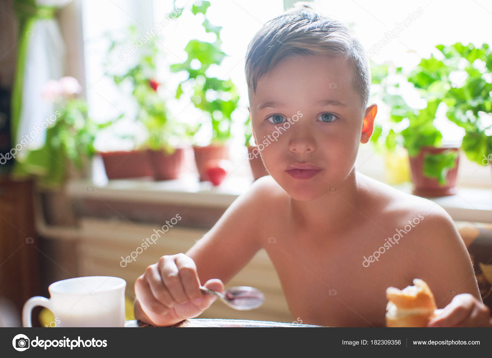 Cute boy ready for breakfast Stock Photo by ©olinchuk 182309356