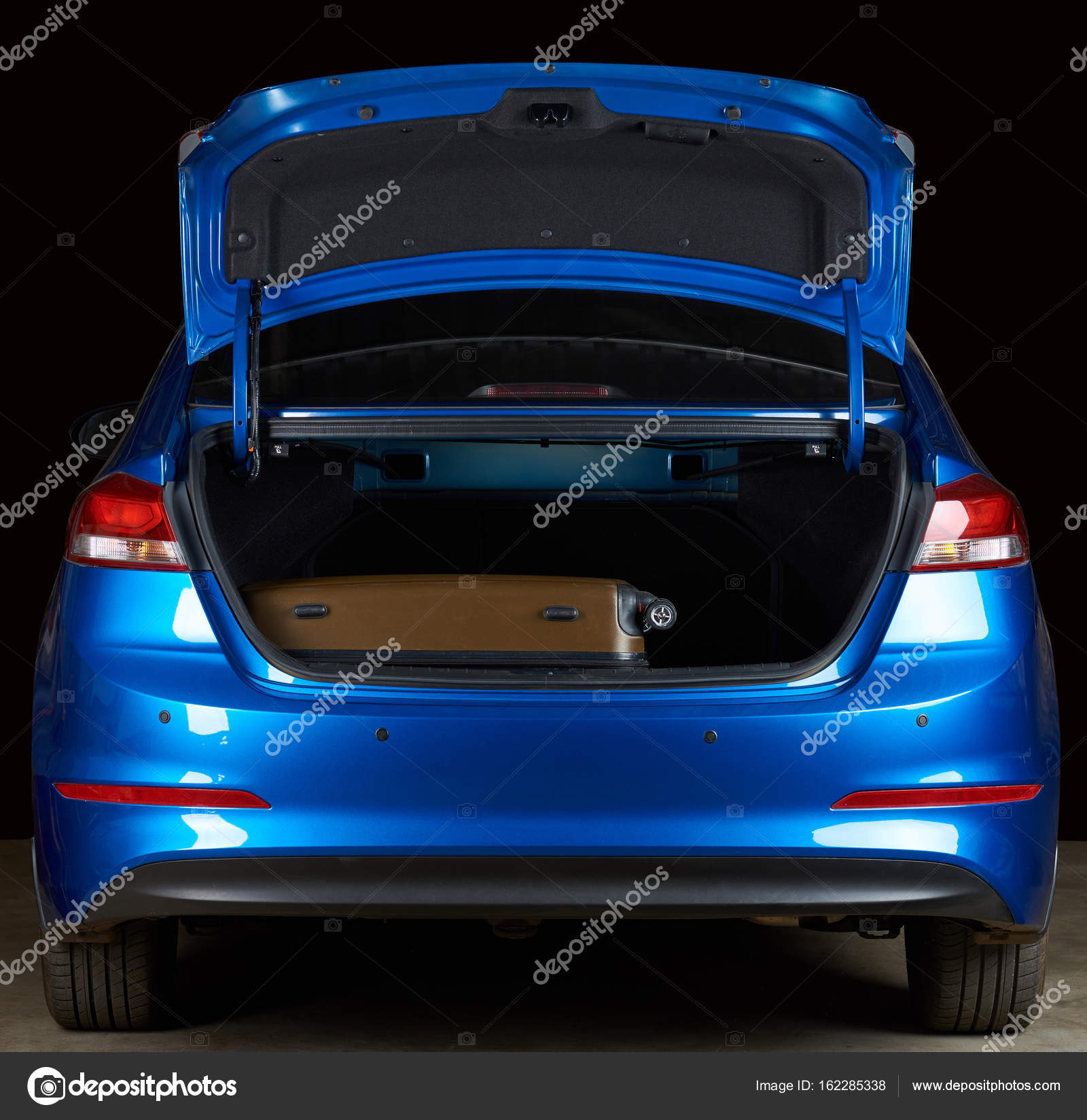 Suitcase in modern car trunk Stock Photo by ©dimarik 162285338
