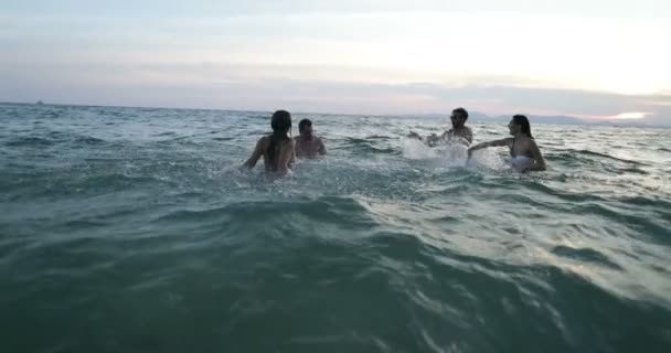 Group Of Cheerful Friends Swimming In Sea At Sunset Young People ...