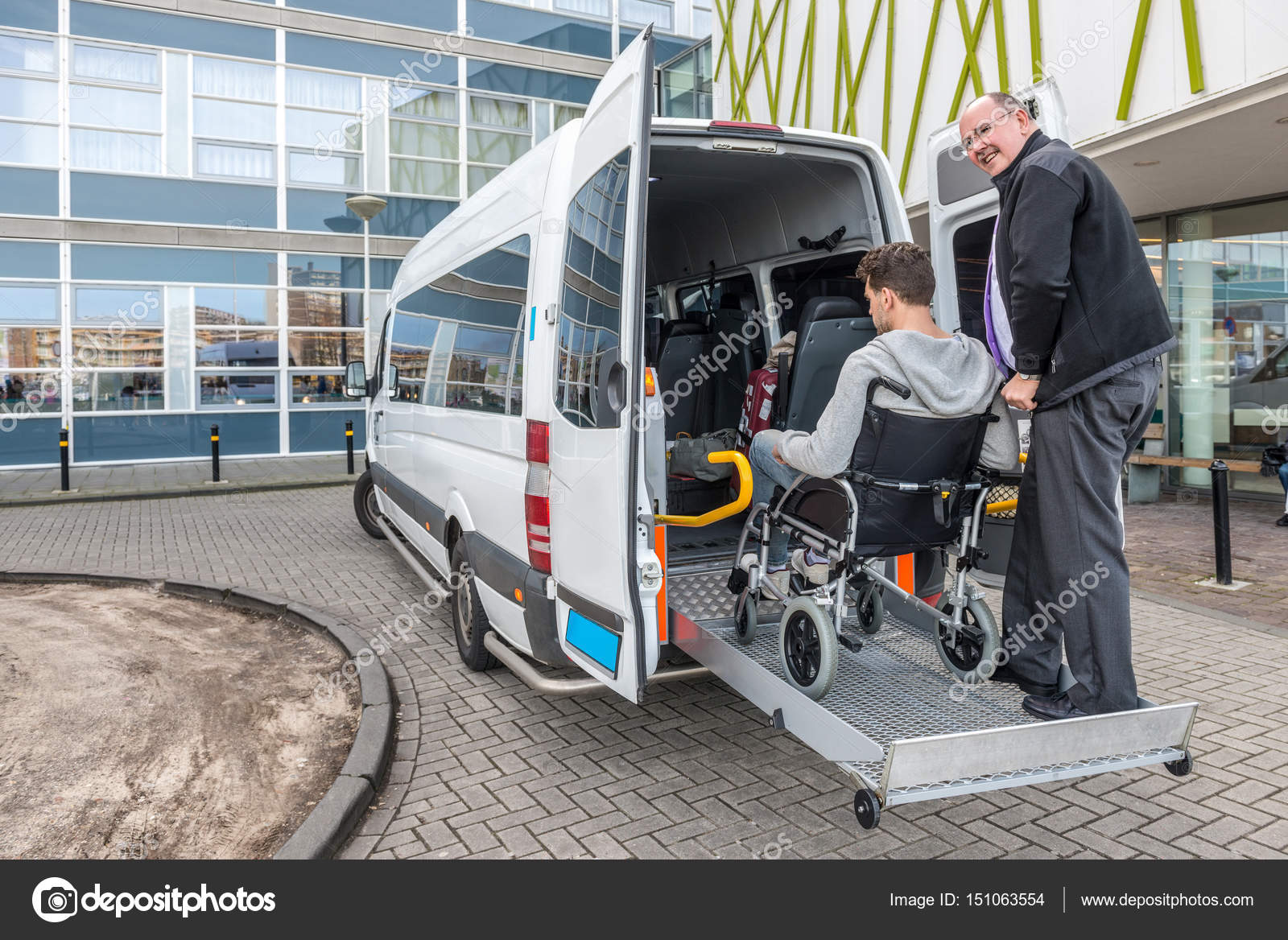 Driver assisting passenger in wheelchair Stock Photo by ©Corepics 151063554