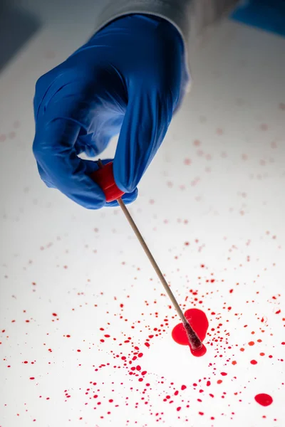 Forensic technician taking DNA sample from blood stain — Stock Photo ...