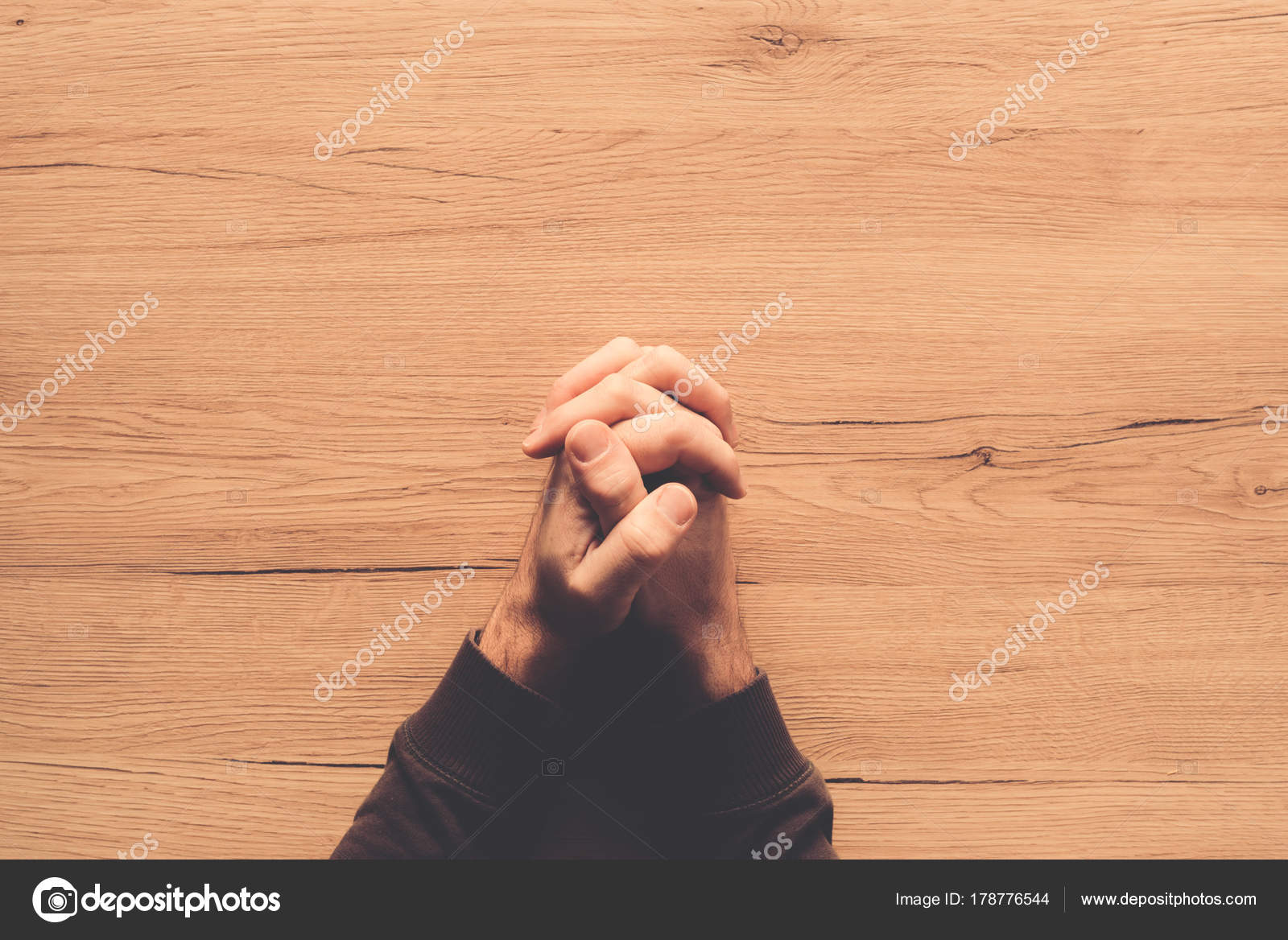 Man praying, overhead view Stock Photo by ©stevanovicigor 178776544
