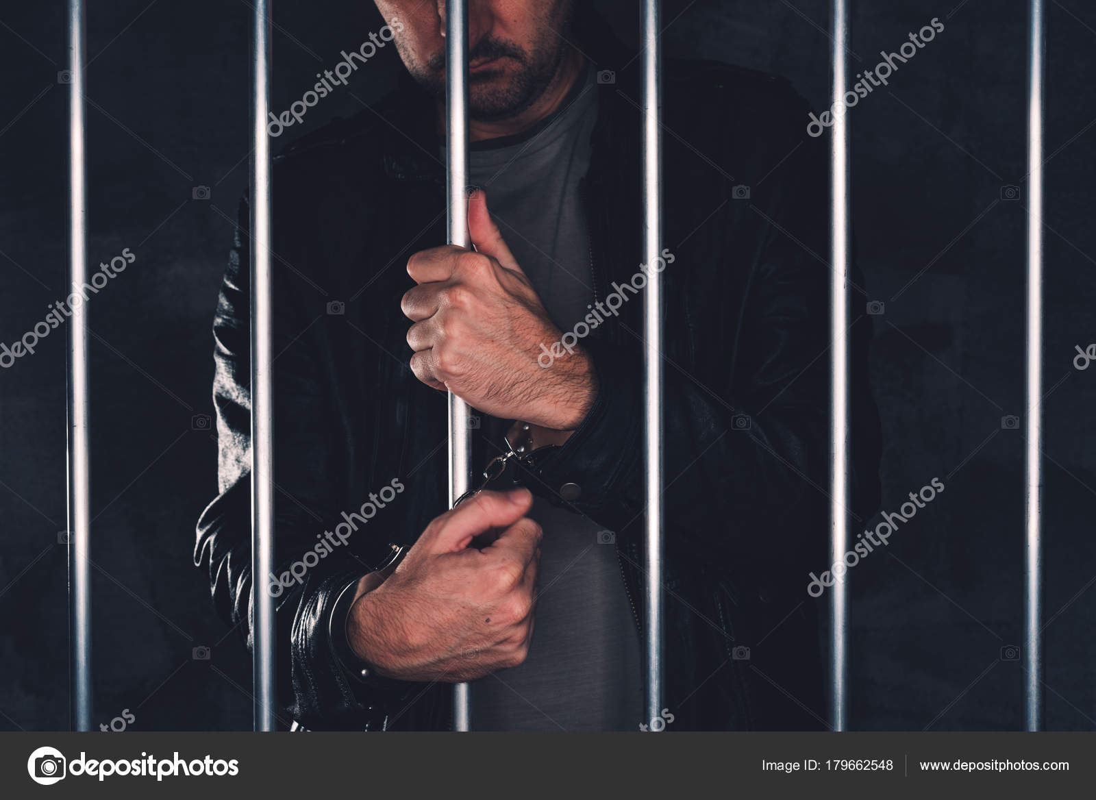 Handcuffed man behind prison bars — Stock Photo © stevanovicigor #179662548