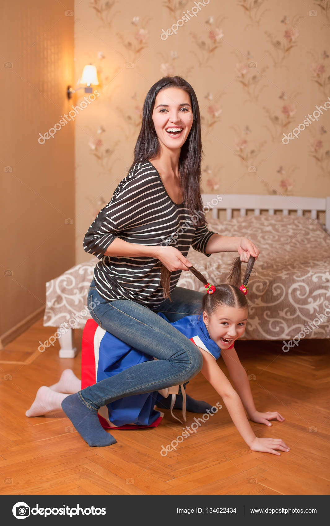 Mother sitting on back of little daughter Stock Photo by ©Nomadsoul1 ...