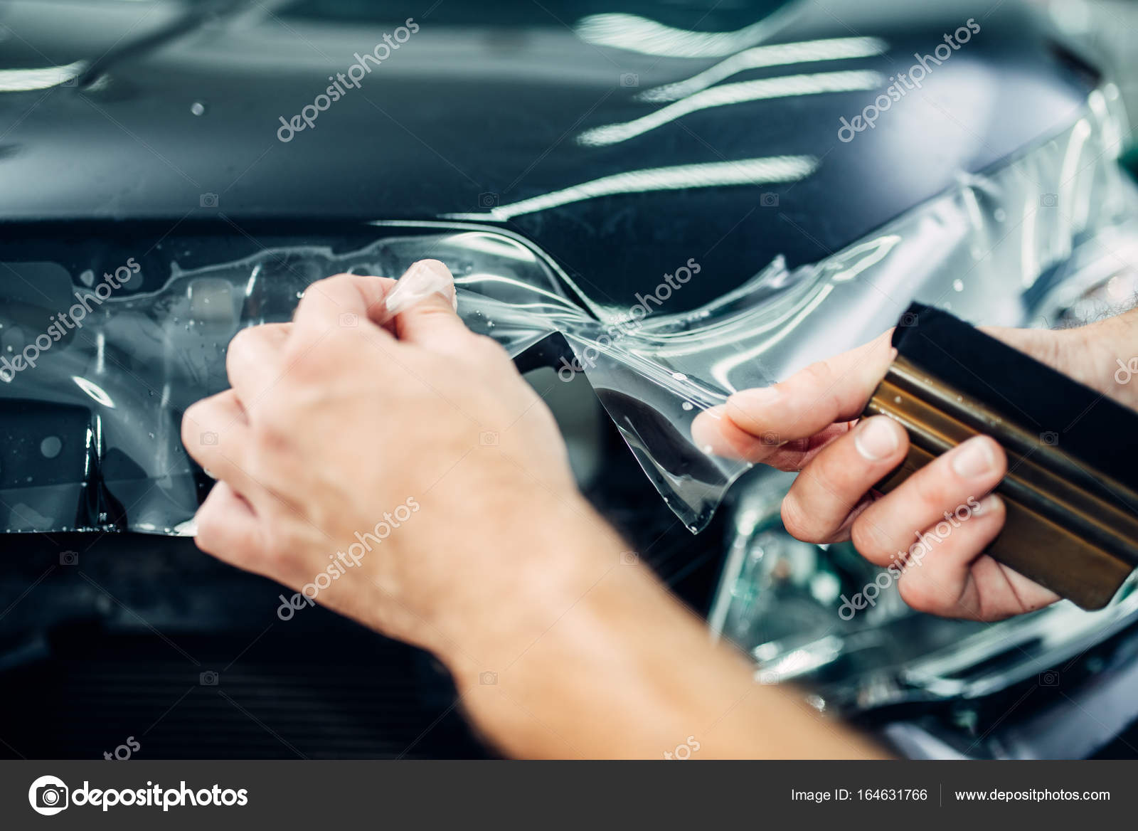 Worker installing car protection film — Stock Photo © Nomadsoul1 #164631766