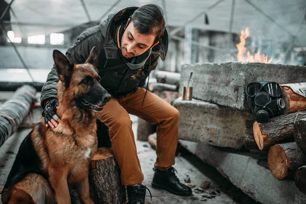 stalker, post-apocalypse soldier feeding dog. Post apocalyptic ...