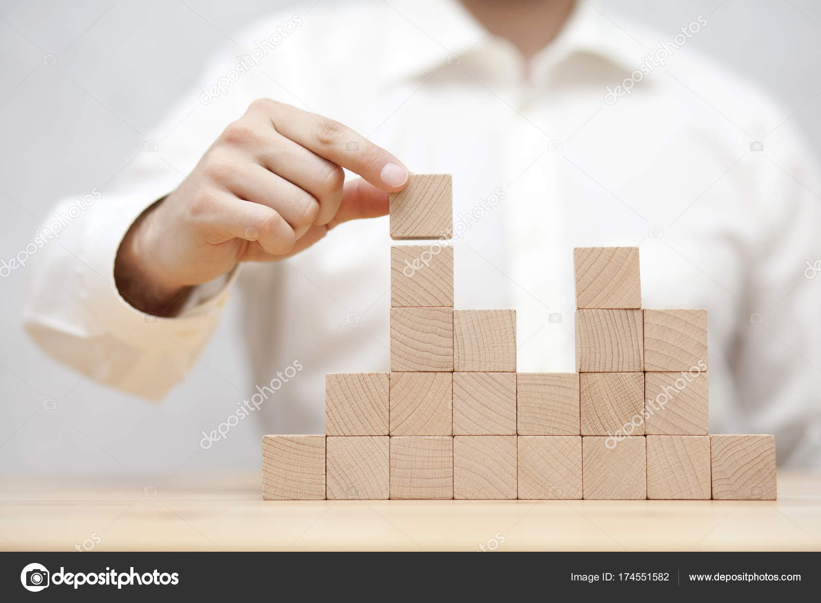 Man's hand stacking wooden blocks. Business development concept Stock ...