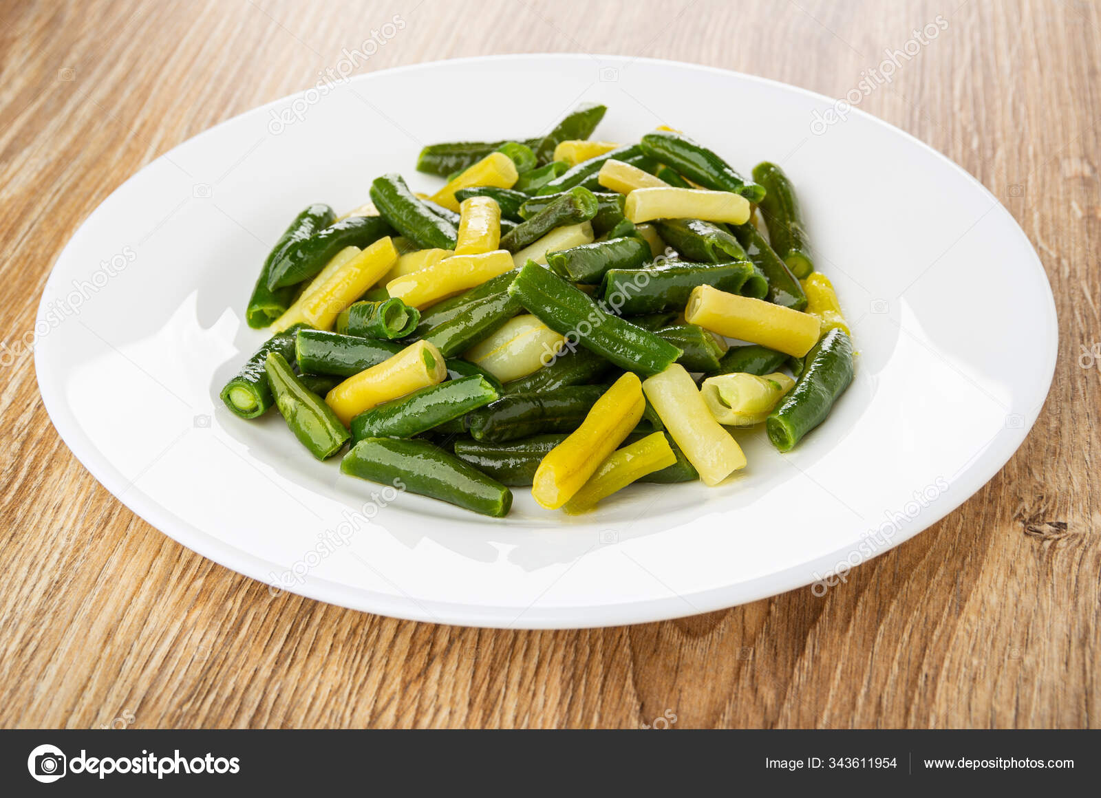 Cooked yellow and green beans in plate on wooden table — Stock Photo ...