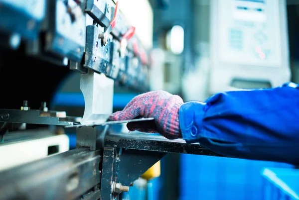 Person controls manufacturing machine Stock Photo by ©zhudifeng 141692878