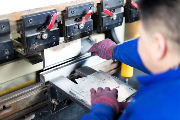 young man working in factory - Stock Image - Everypixel