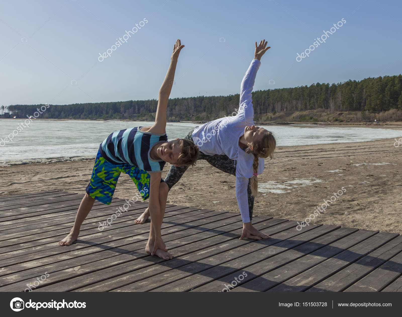 Young woman and boy doing Extended side angle pose. — Stock Photo ...