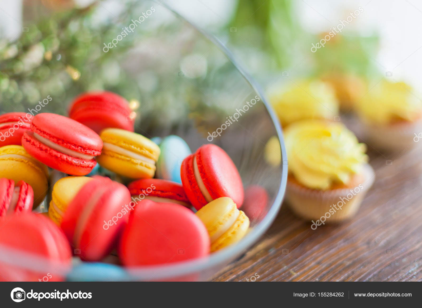 Bright macaroons and cupcakes Stock Photo by ©dvoevnore 155284262