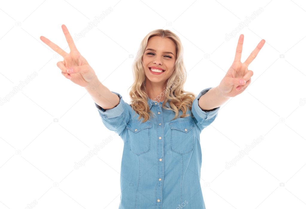 Excited young blonde woman making the victory sign Stock Photo by ...