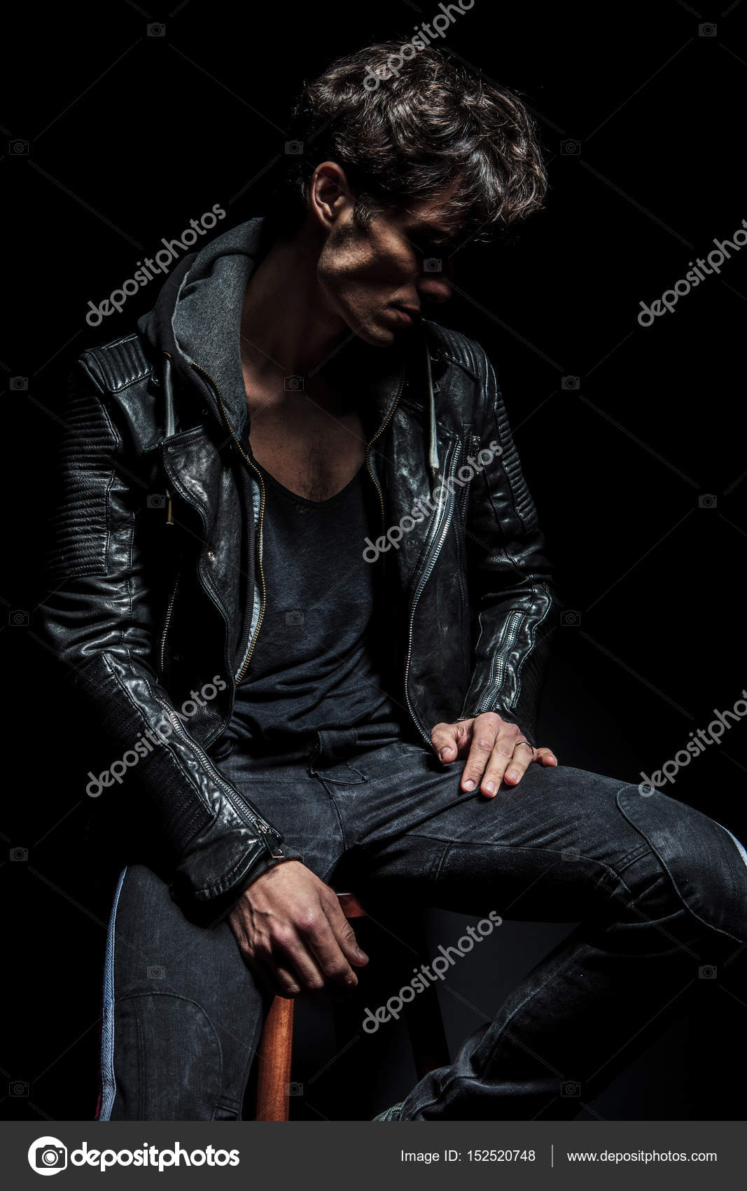 Side view of a punk looking down while sitting ⬇ Stock Photo, Image by ...